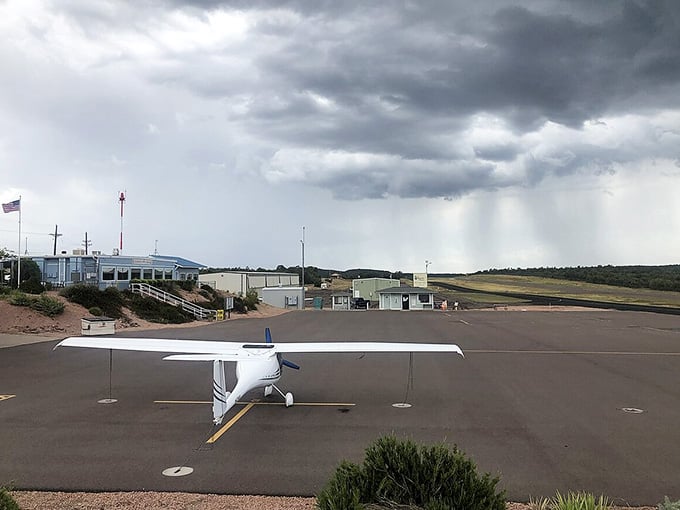 Storm clouds gather dramatically over the airfield, reminding us that even small towns have big skies.