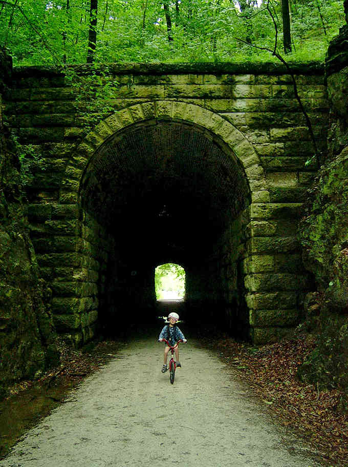 Like something from Indiana Jones, this moss-covered stone tunnel beckons adventurous souls into its mysterious depths.