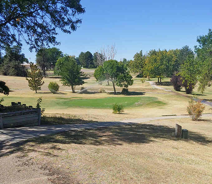Green fairways stretch across prairie landscape, offering golfers a peaceful escape where eagles outnumber birdies by plenty.