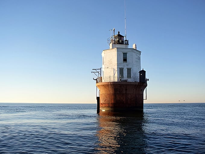 The calm waters mirror this lighthouse's serene confidence, creating a scene so peaceful it could lower your blood pressure.