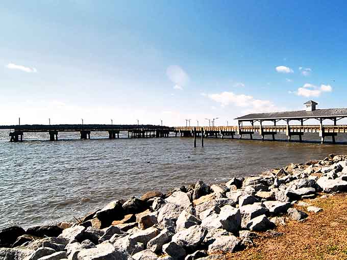 The fishing pier stretches into calm waters where patience gets rewarded and worries drift away with the tide.