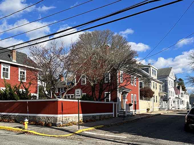Residential streets here feature colorful homes packed close together, creating the cozy neighborhood feeling that defines coastal Connecticut village living perfectly.
