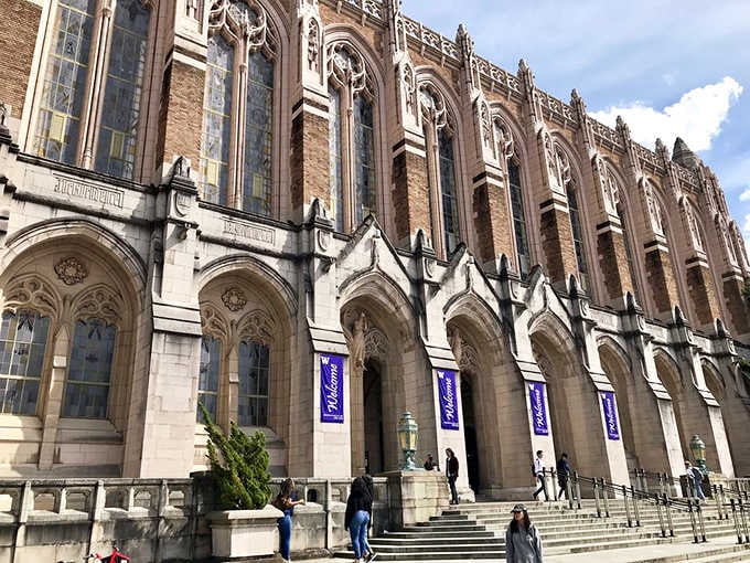 Pointed arches march along the facade while purple banners add splashes of color to centuries-old architectural style.