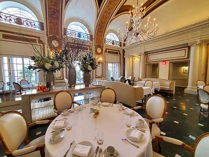 The ornate ceiling details and elegant table settings create an atmosphere of Belle &Eacute;poque luxury and refinement.