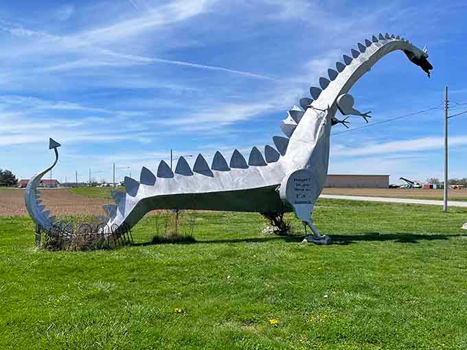 The metallic dragon curves its spiky tail across the grass, a whimsical guardian watching over passing travelers with mythical charm.