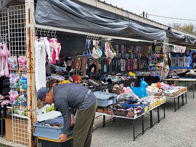Vendors arrange their wares under tarps while pink stuffed animals and colorful accessories create displays more organized than most retail stores.