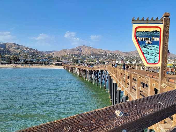 Ventura Pier stretches into turquoise waters with hills rising behind creating that perfect California postcard you've been seeking.