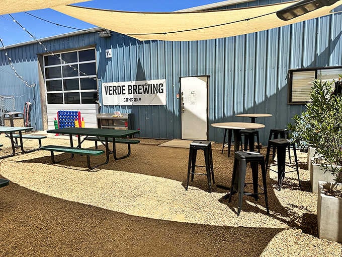 That simple outdoor patio setup with picnic tables is where cold craft beer meets warm desert sunshine perfectly.