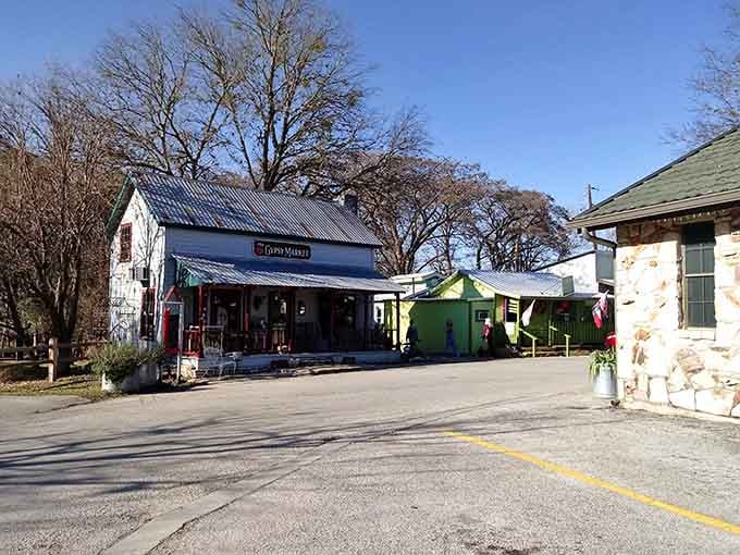 Bare winter branches arch over colorful storefronts, proving this town looks stunning in every season of the year.