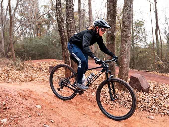 Threading through autumn leaves on red clay, this rider makes navigating technical terrain look easier than parallel parking.