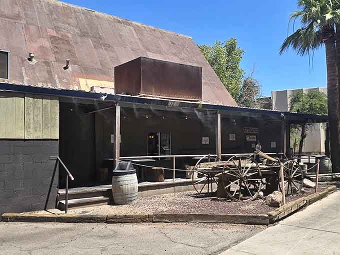 An old wagon wheel and weathered wood facade that looks more Wild West than burger joint, perfectly.