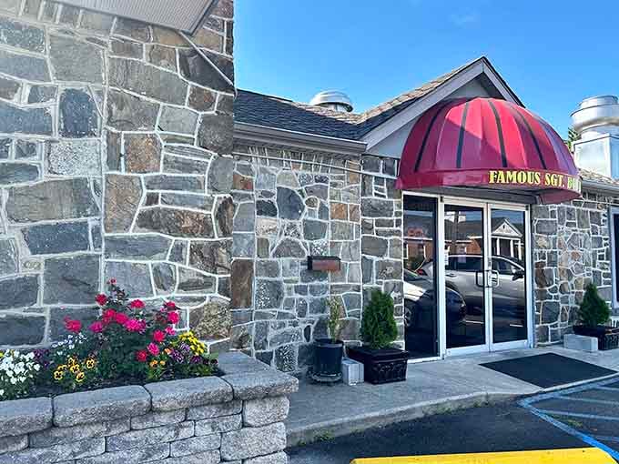 The charming stone exterior with its eye-catching red awning creates an inviting entrance that promises great things await inside.