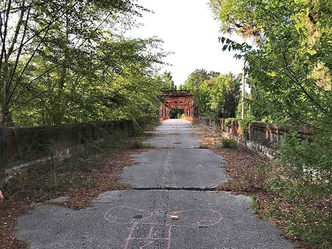 That iconic red bridge stretching across the Suwannee isn't just photogenic, it's your gateway to forgotten Florida history.