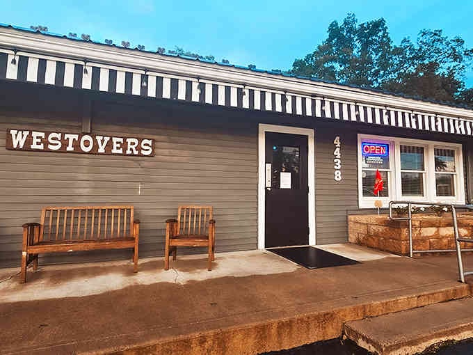 That striped awning and wooden benches whisper "come sit and stay awhile" louder than any neon sign ever could.