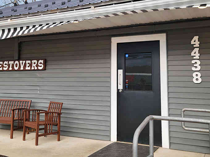 That striped awning and wooden benches whisper "come sit and stay awhile" louder than any neon sign ever could.