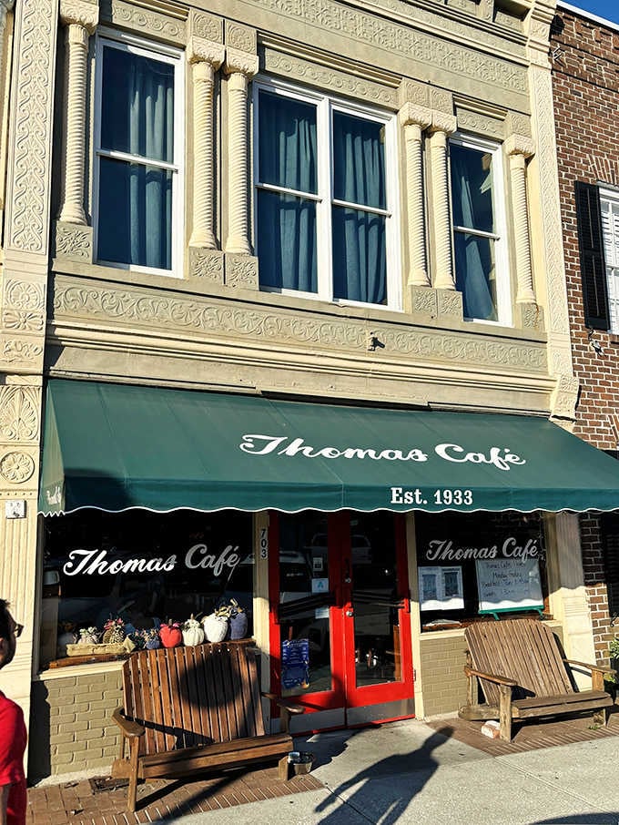 That green awning has been calling hungry souls since 1933, and those red doors open to breakfast paradise.