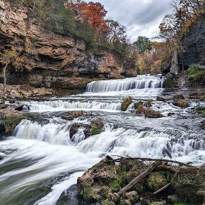 Nature's staircase in full autumn glory, where water and ancient rock create poetry in motion.