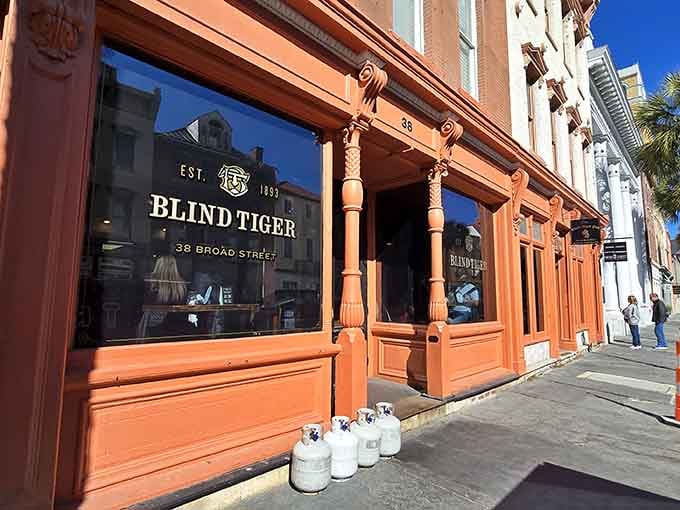 That coral-colored storefront isn't just pretty, it's basically a lighthouse guiding you to excellent cocktails and possible ghost encounters.