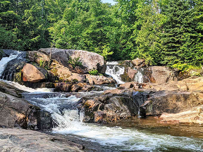 Nature's staircase in full glory, where water dances over rust-colored rocks like a liquid ballet performance.