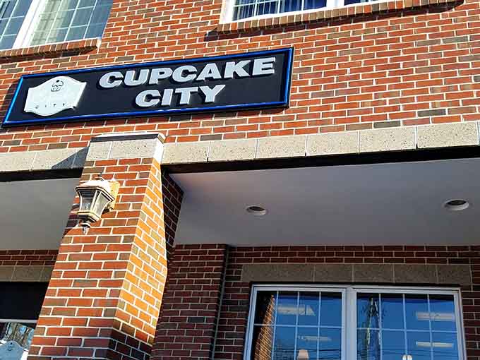 The sign says it all: Cupcake City, where democracy meets dessert and everyone gets their own perfect portion.