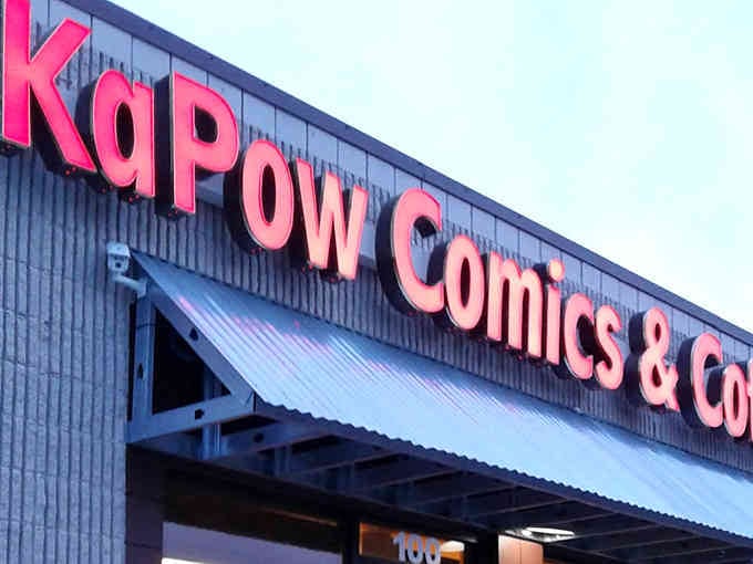 That bold red signage isn't just announcing a comic shop—it's declaring a revolution in caffeine delivery systems.