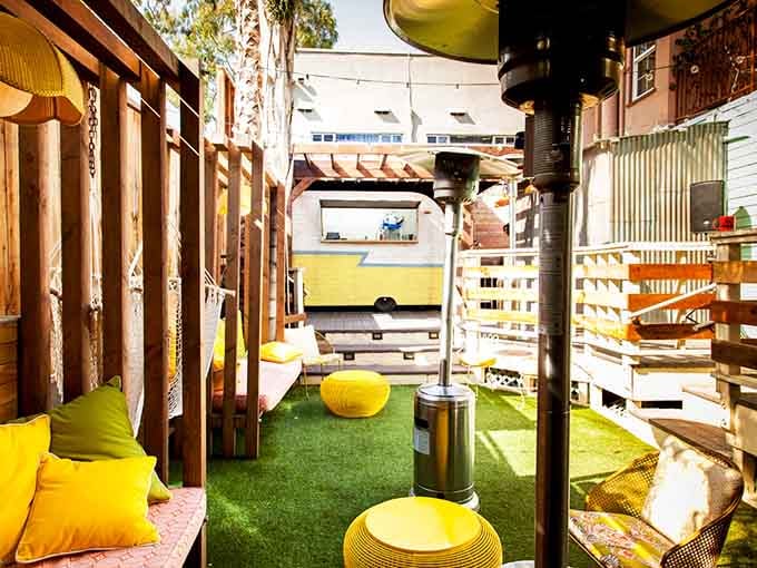 Yellow cushions and fake grass create the kind of outdoor oasis your parents dreamed about in their Sears catalog.