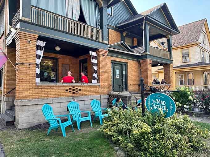 Victorian charm meets Wonderland magic on this porch, where striped stockings dangle overhead and turquoise chairs invite lingering conversations over coffee.