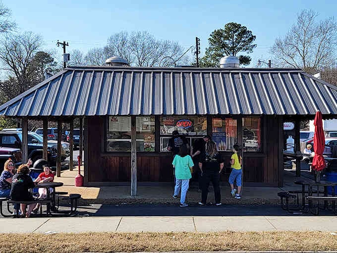 That striped metal roof and wooden exterior promise one thing: honest food at prices that won't hurt your wallet.