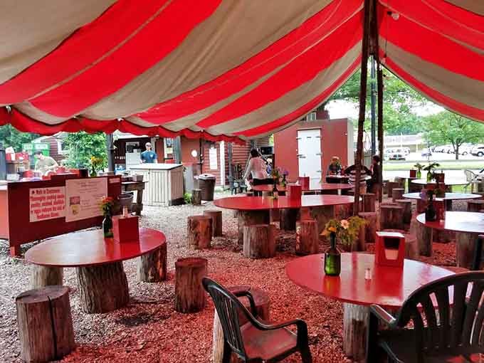 Tree stumps as chairs, red picnic tables, and a canopy overhead: this is where Connecticut does fine dining, just without the fine part.