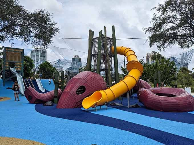That yellow tube slide looks like a sea serpent decided to moonlight as playground equipment, and honestly, we're here for it.