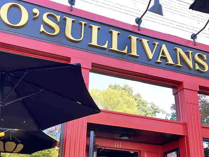 That bold red facade and gleaming gold lettering practically shout "come in for a pint" louder than any Irish uncle.
