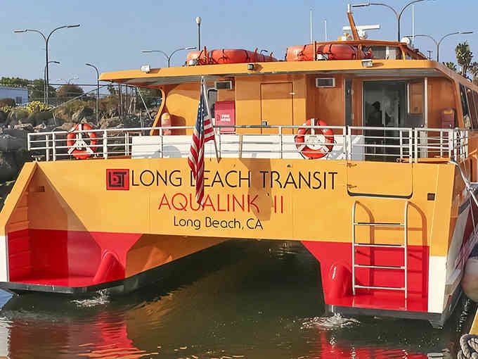 That cheerful yellow and red catamaran isn't just pretty, it's your ticket to waterfront bliss in Long Beach.