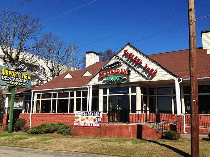 The brick facade and welcoming windows promise comfort food with a side of runway views you won't forget.