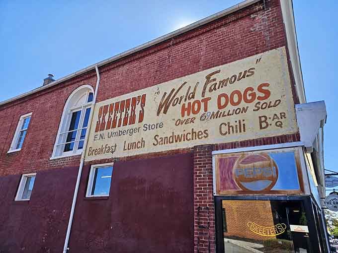 Window paintings advertising hot dogs and ice cream work better than any fancy billboard ever could for hungry travelers.