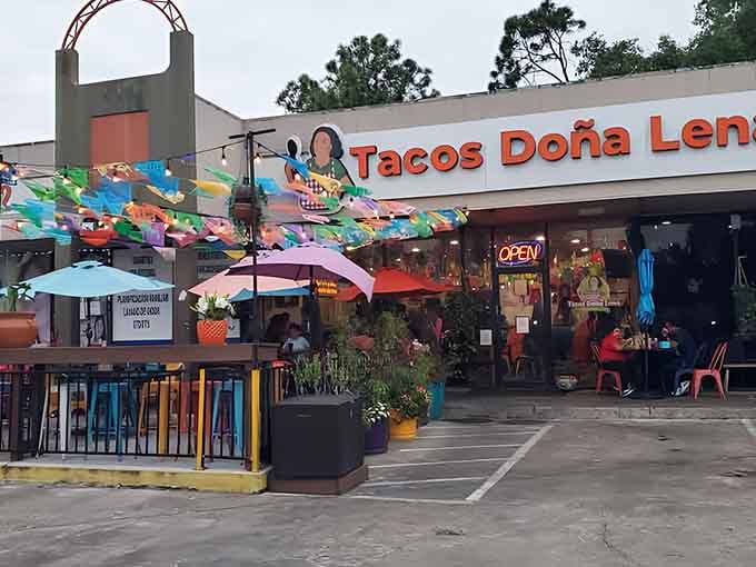The vibrant patio and festive banners transform an ordinary parking lot into your new favorite dining destination immediately.