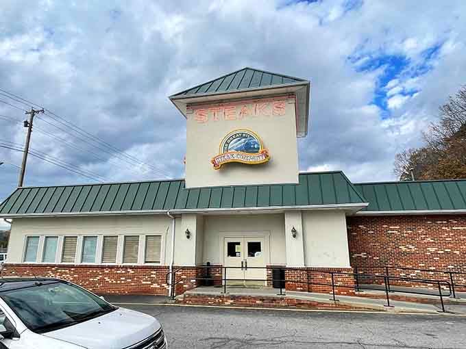 That green metal roof and railroad-inspired architecture signal you've arrived at steak heaven with a side of nostalgia.