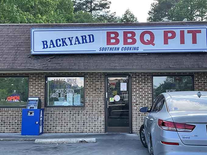 That modest brick facade hides some of Durham's most sought-after barbecue, where the real magic happens out back.