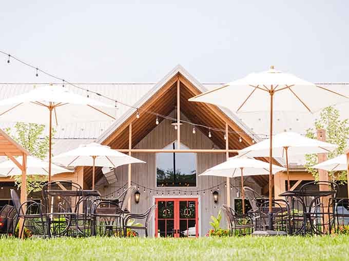 The patio setup with those crisp white umbrellas looks like a European vacation without the jet lag.