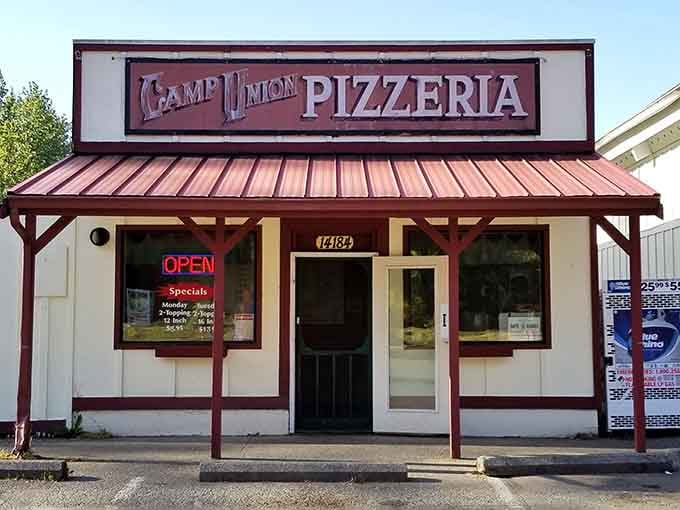 This unassuming little building houses pizzas so big they practically need their own area code.
