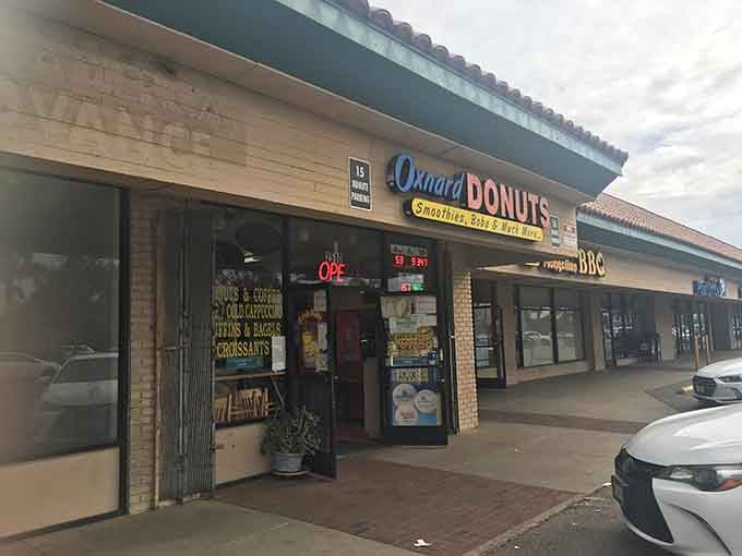 That cheerful storefront sign promises smoothies, boba, and "much more," which is donut-speak for pure happiness.