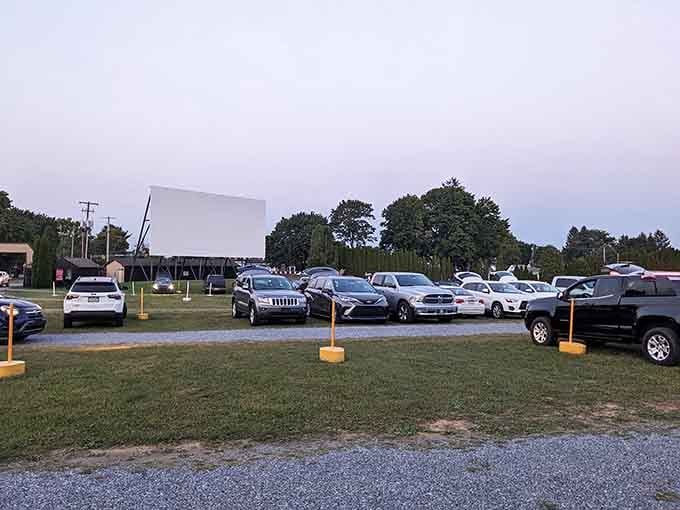 The towering screen stands ready to transport you back to simpler times when entertainment meant fresh air and freedom.