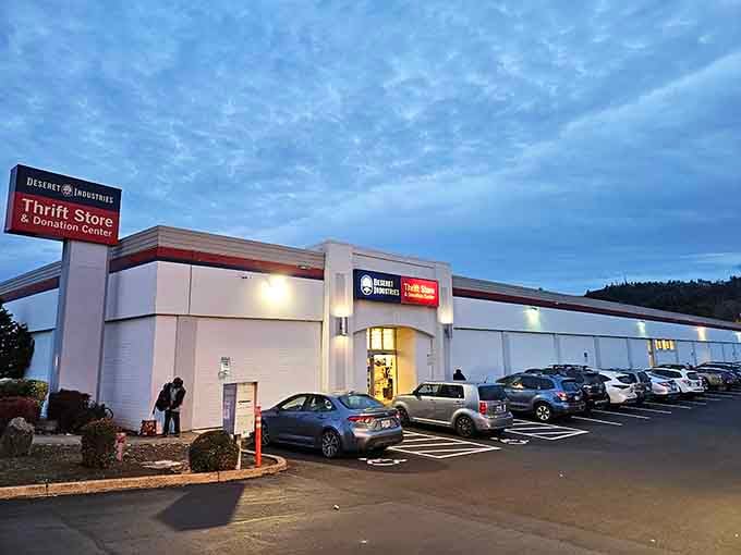 As evening falls, the lights beckon thrift shoppers like moths to a flame, promising treasures waiting to be discovered.