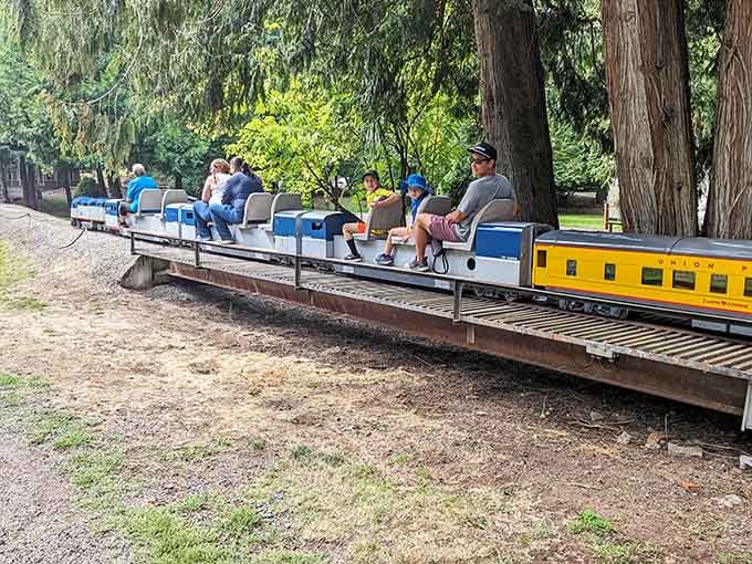 Passengers of all ages ride astride the miniature train cars, grinning like they've just discovered the fountain of youth.