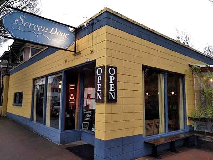 That cheerful yellow and blue exterior is like a beacon calling you home to breakfast paradise.