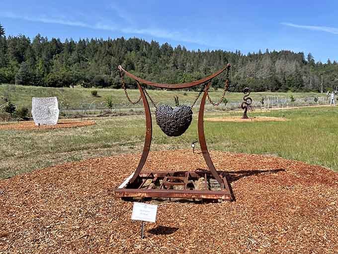 Metal meets meadow in this suspended sphere sculpture, where rusty chains cradle creativity against wine country's endless sky.
