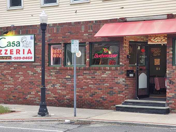 That classic brick facade and neon glow signal you've arrived at pizza paradise in Ludlow's friendly neighborhood.
