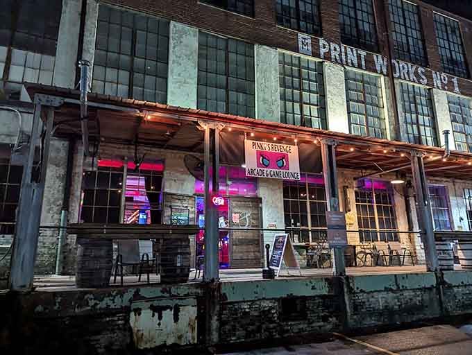 The neon glow beckons from the historic Print Works building, promising an evening of pure retro joy inside.