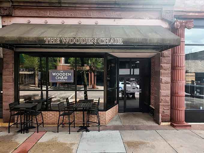 The Wooden Chair beckons from downtown Stevens Point, promising breakfast dreams and outdoor seating when Wisconsin weather cooperates.
