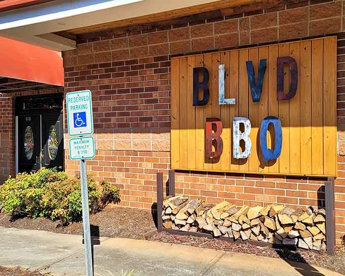 That colorful sign and stacked firewood aren't just decoration &ndash; they're a promise of smoky deliciousness ahead.