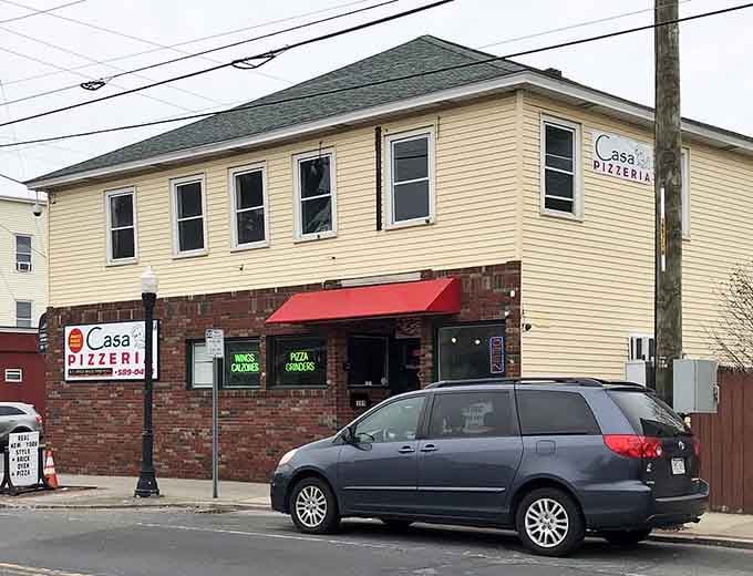 That cheerful red awning and brick facade hide some of the finest craft pizza you'll find anywhere in Massachusetts.